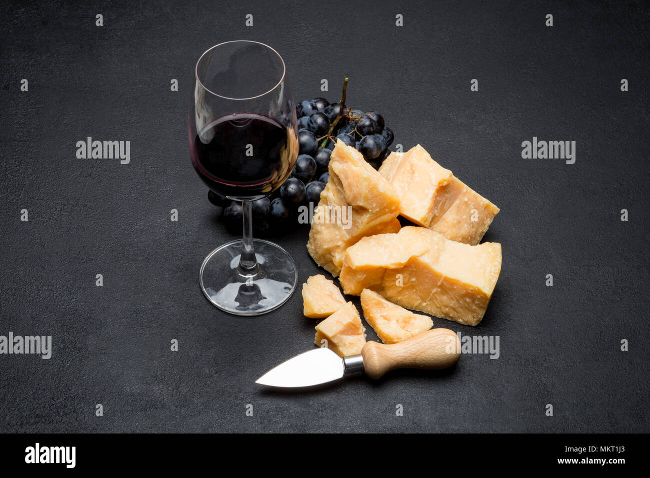pieces of parmesan or parmigiano cheese, wine and grapes Stock Photo ...