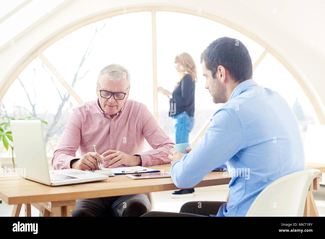 Shot of business management working together at the office. Senior ...
