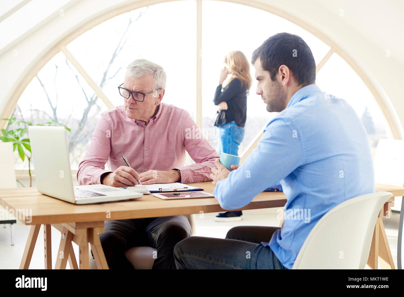 Shot of business management working together at the office. Senior ...
