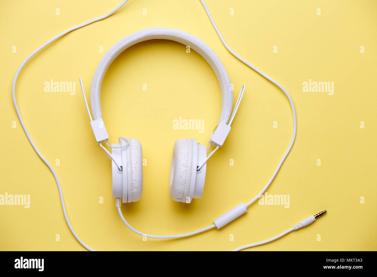 Picture of white headphones for music on yellow background Stock Photo ...