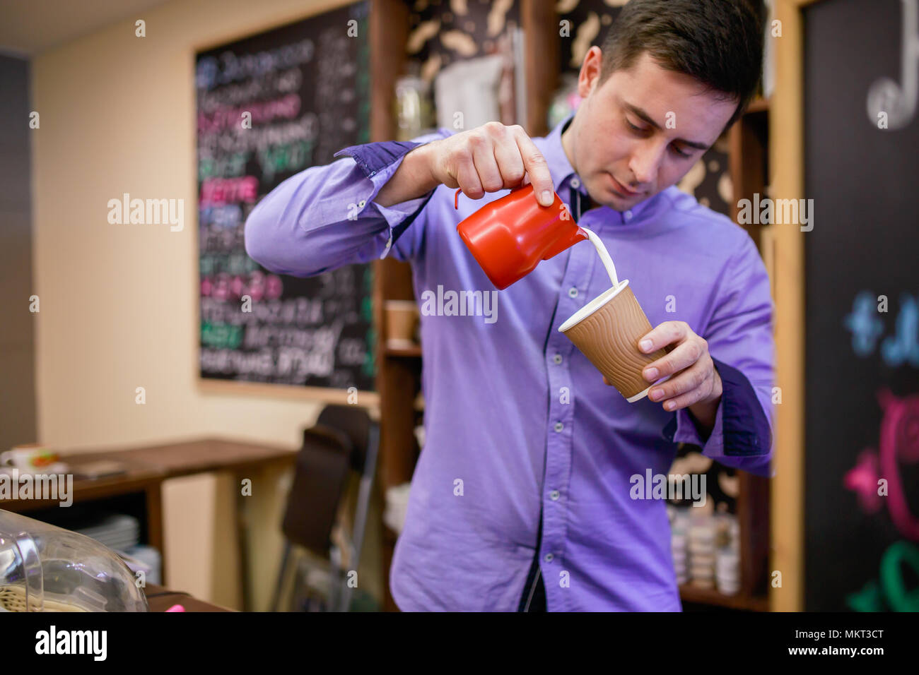 Photo of young barista men pouring cream in coffee Stock Photo - Alamy