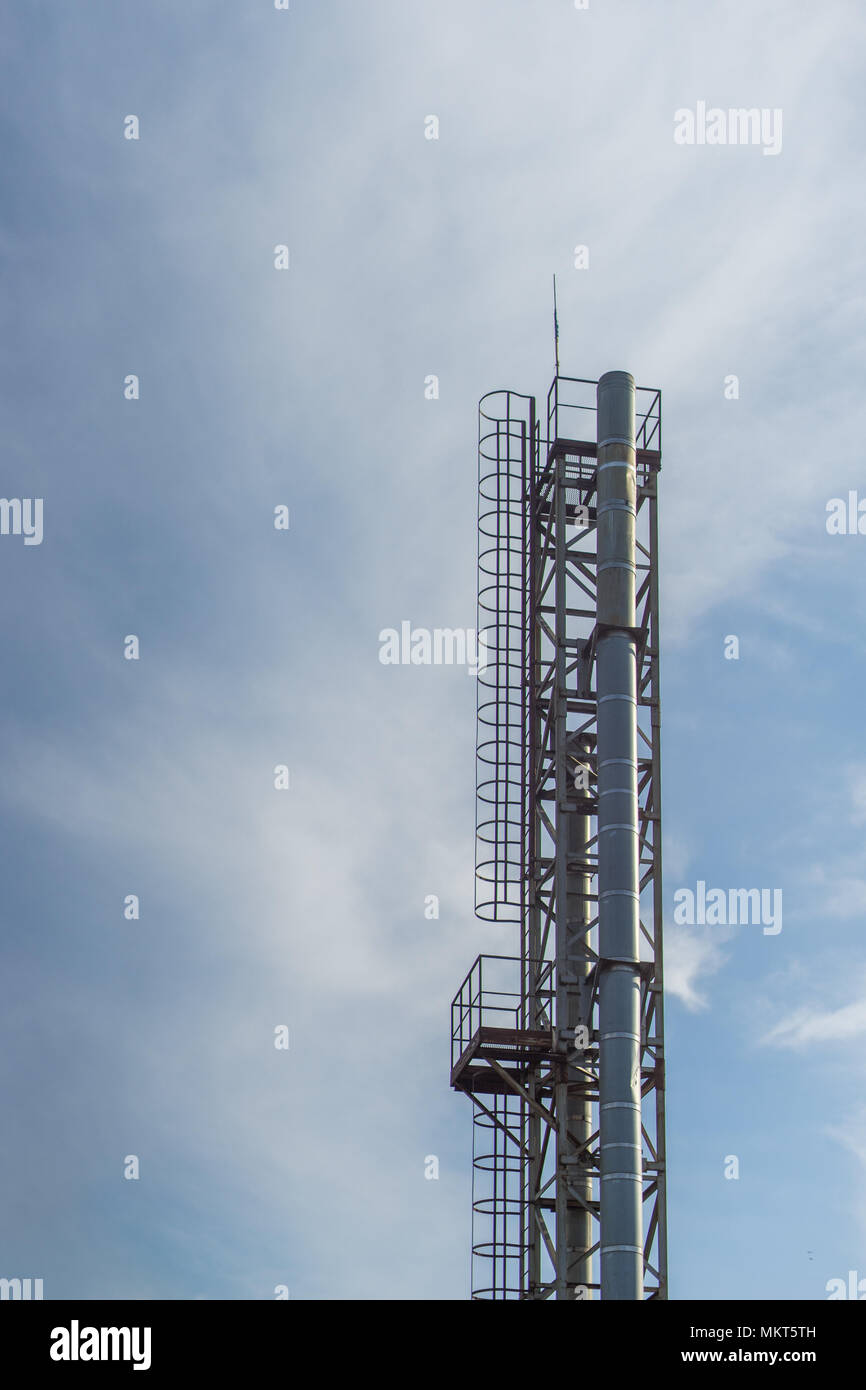 Metal pipe with a ladder Stock Photo - Alamy