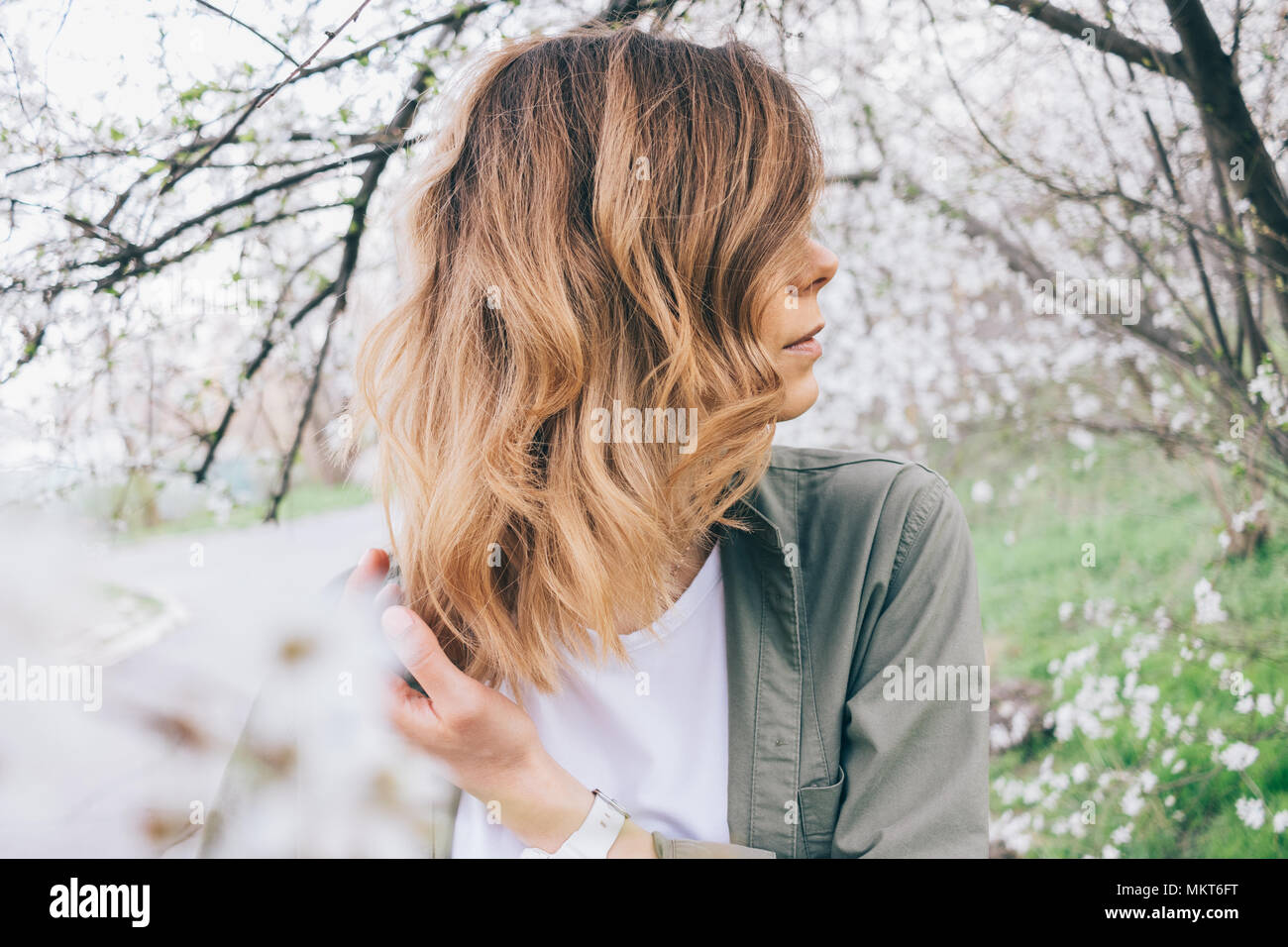 Side view close-up of female hairstyle long wavy bob. Young woman ...