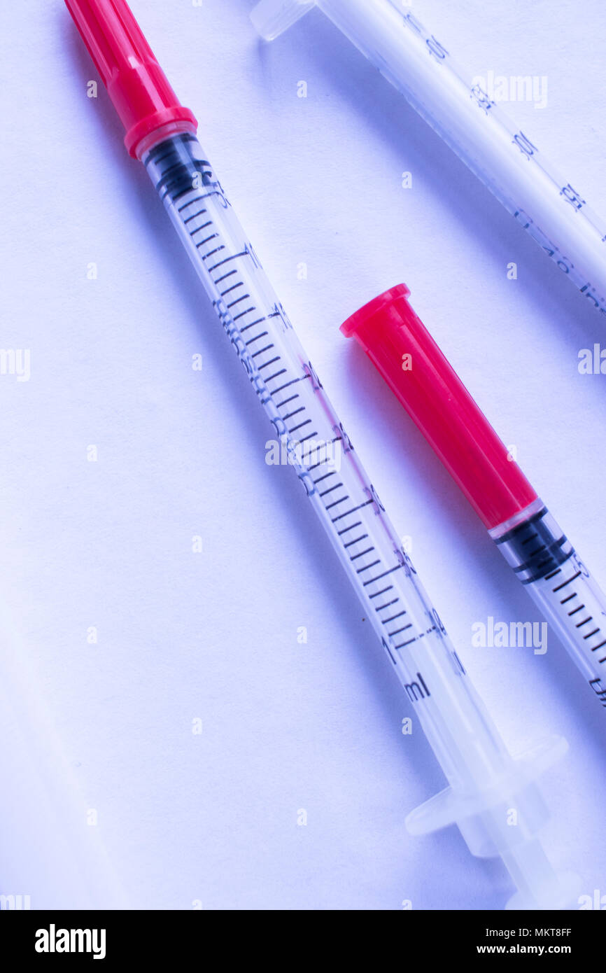 Medical syringe for injections isolated in red and white for insulin ...