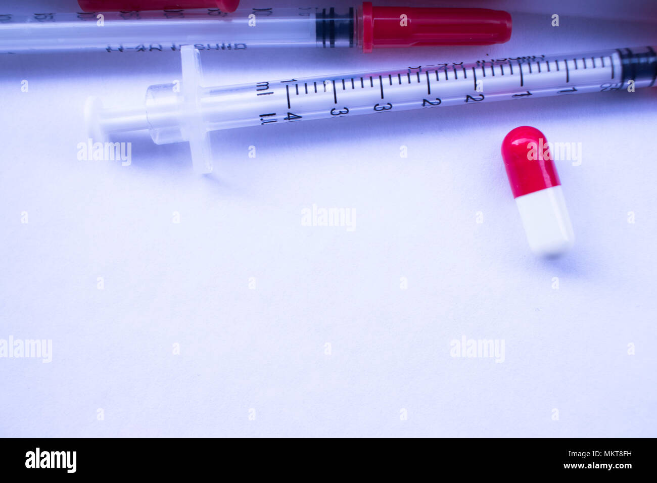 Medical syringe for injections isolated in red and white for insulin ...