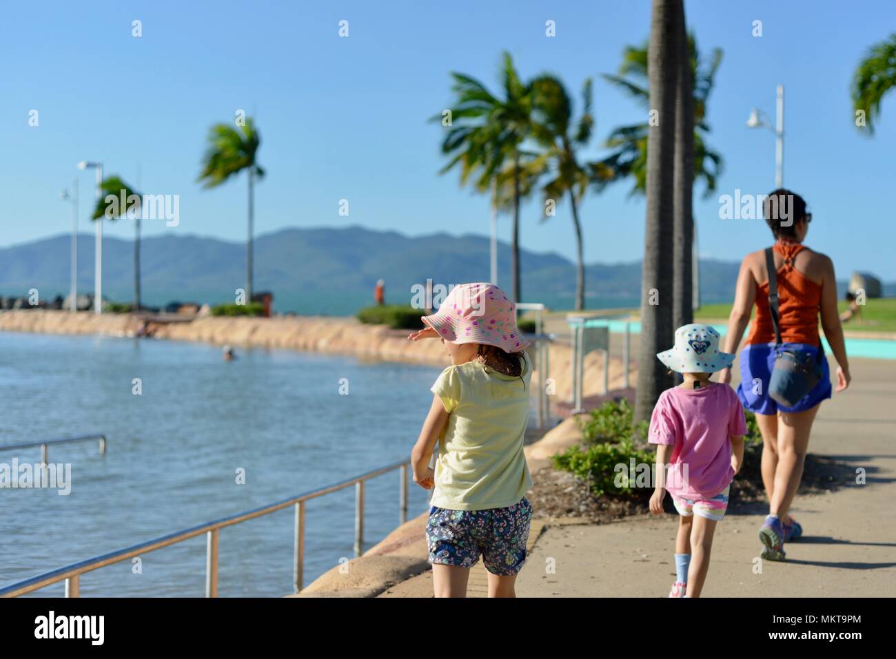 Mother and children walking together in the late afternoon around the ...