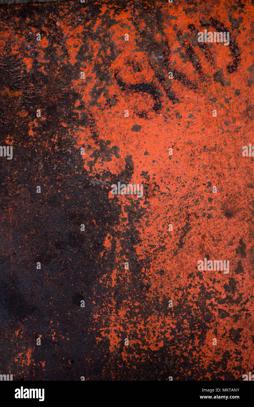 Gritty bright red texture on a rusted metal with the word "skid Stock ...