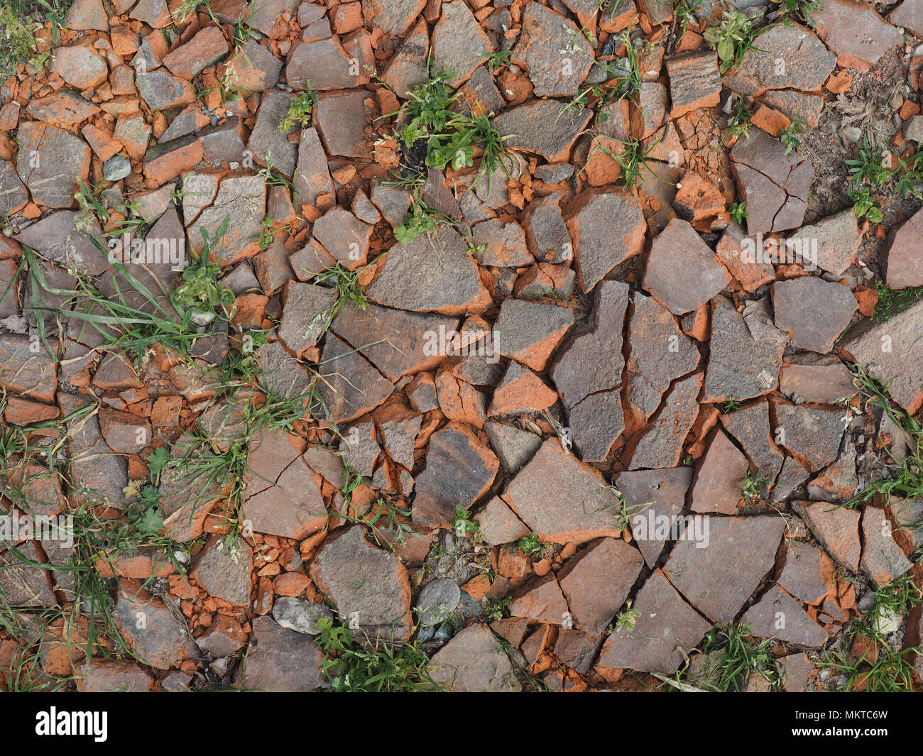 brick red debris rubble of cracked roof tiles useful as a background ...