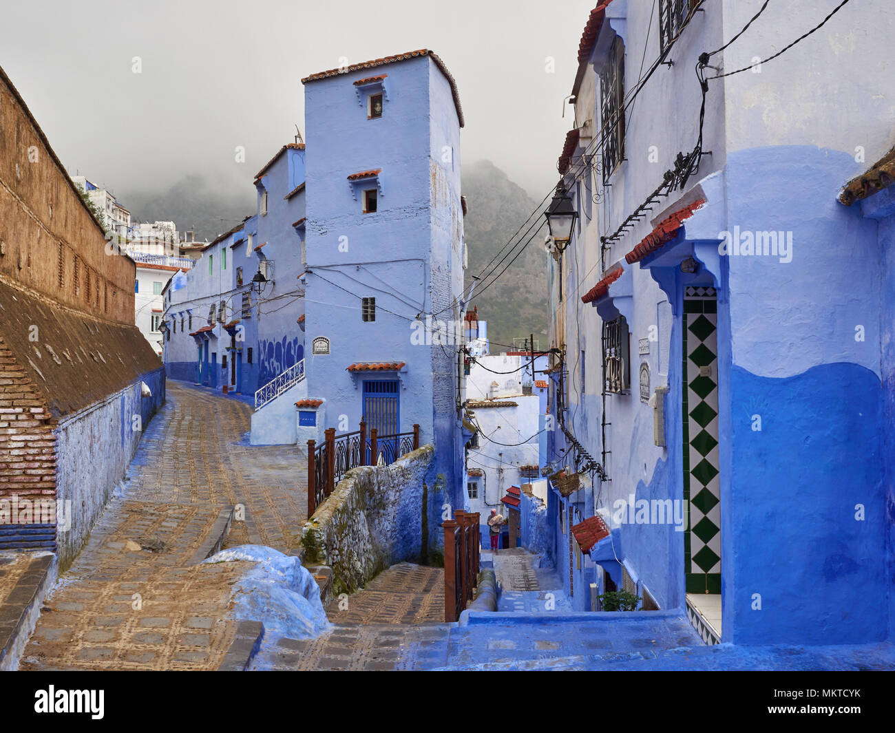Medina, the old town of Chefchaouen: paved brown tiles, narrow ...