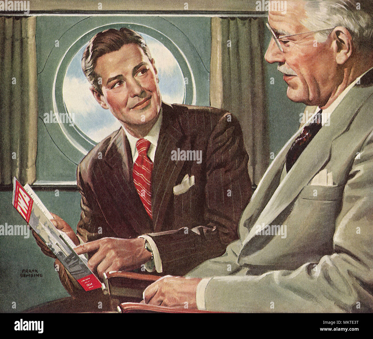 Two Men look at Magazine in Airplane Stock Photo - Alamy