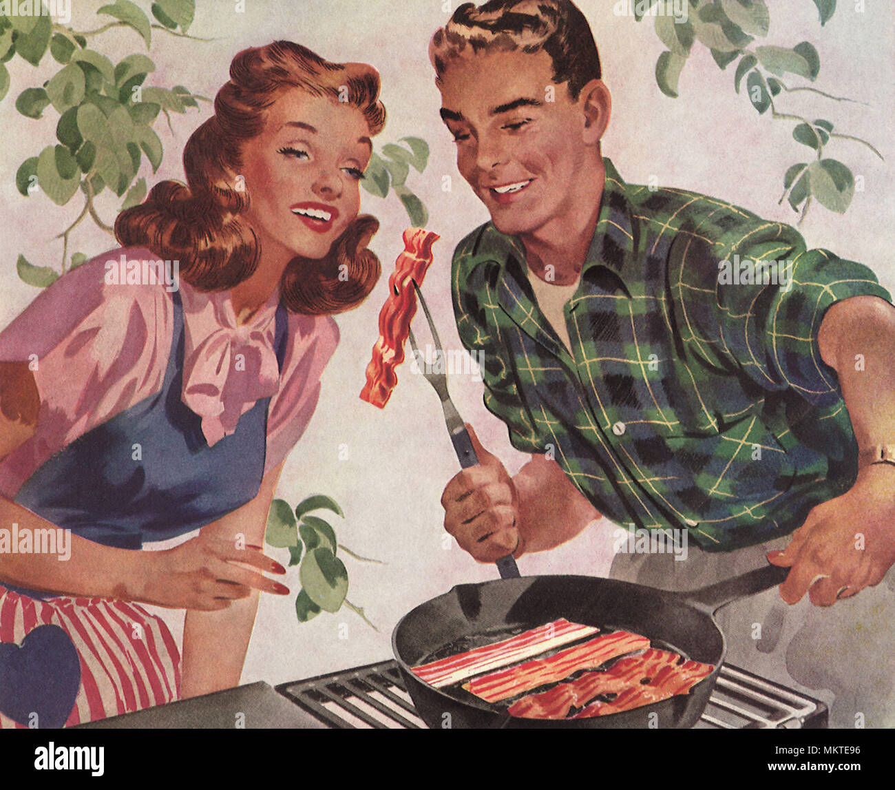 Young Couple cooks Bacon Stock Photo - Alamy