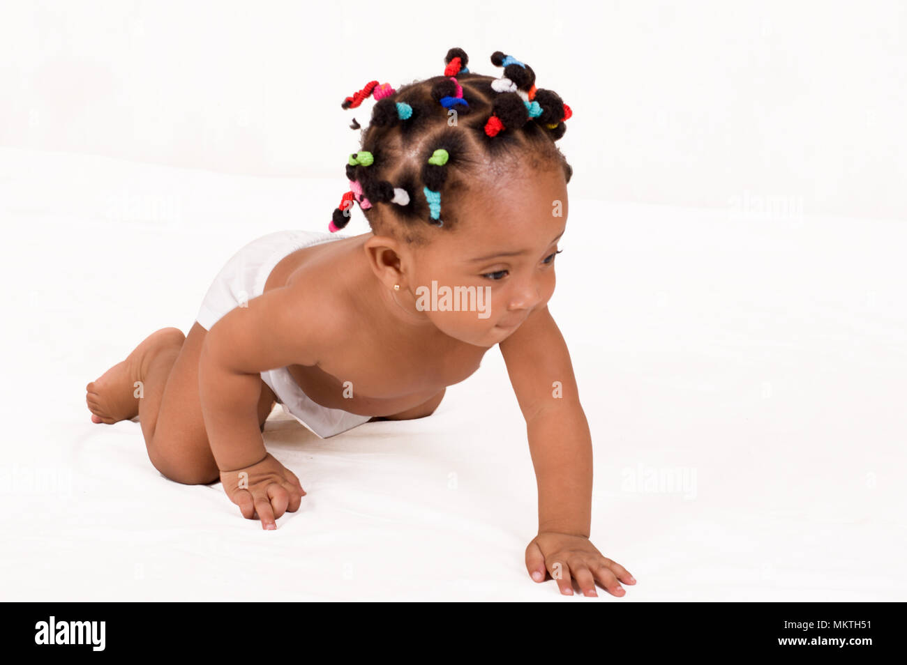 Cute baby girl creeping in layers, advancing towards her mom Stock ...