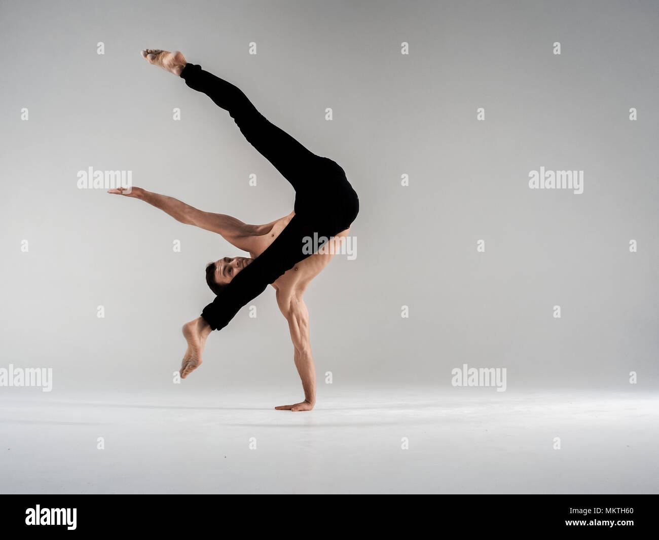 Modern ballet dancer performing art jump with empty copy space ...