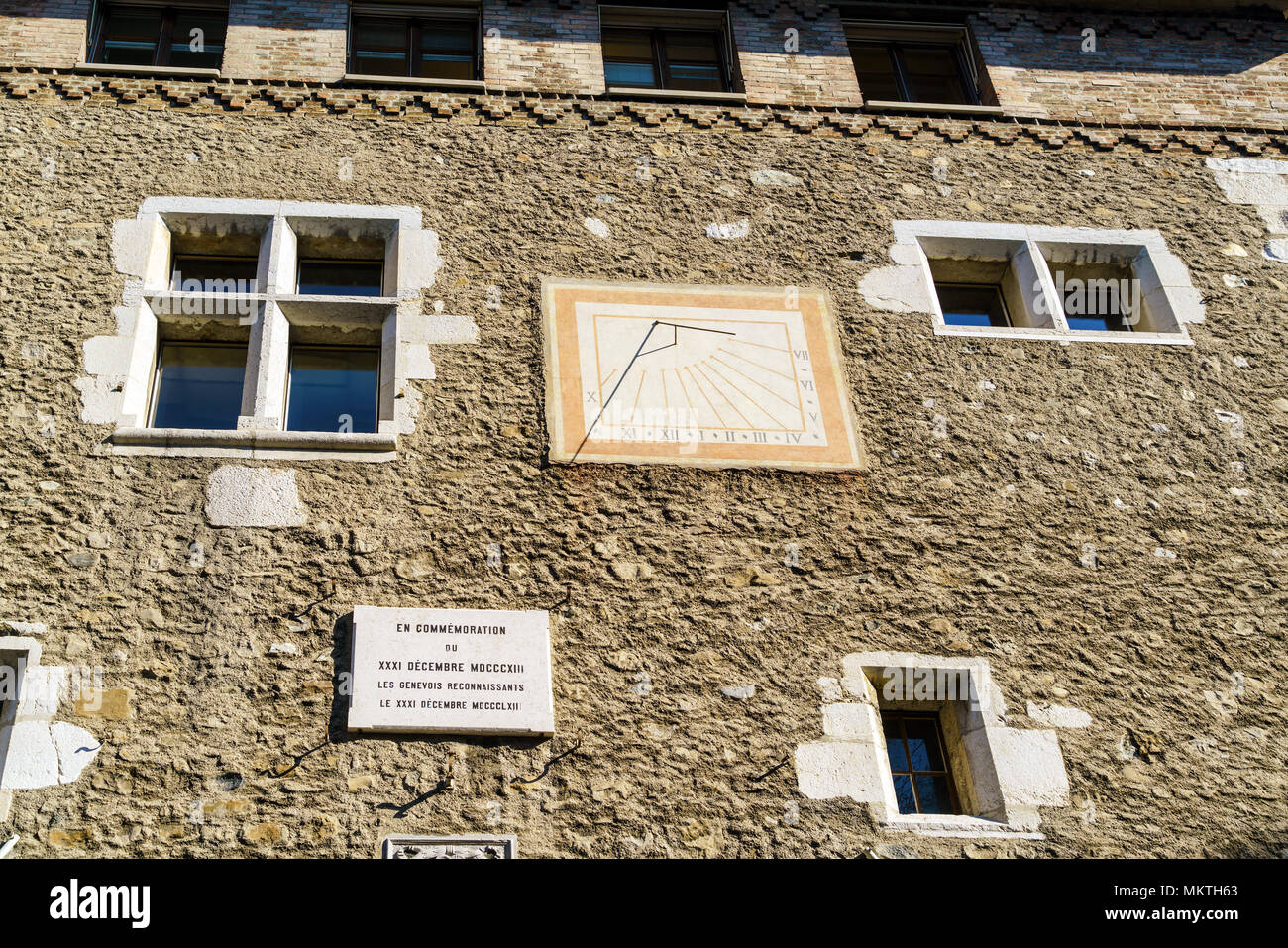 Wall of old house with sun clock and memorial sign board, Geneva ...