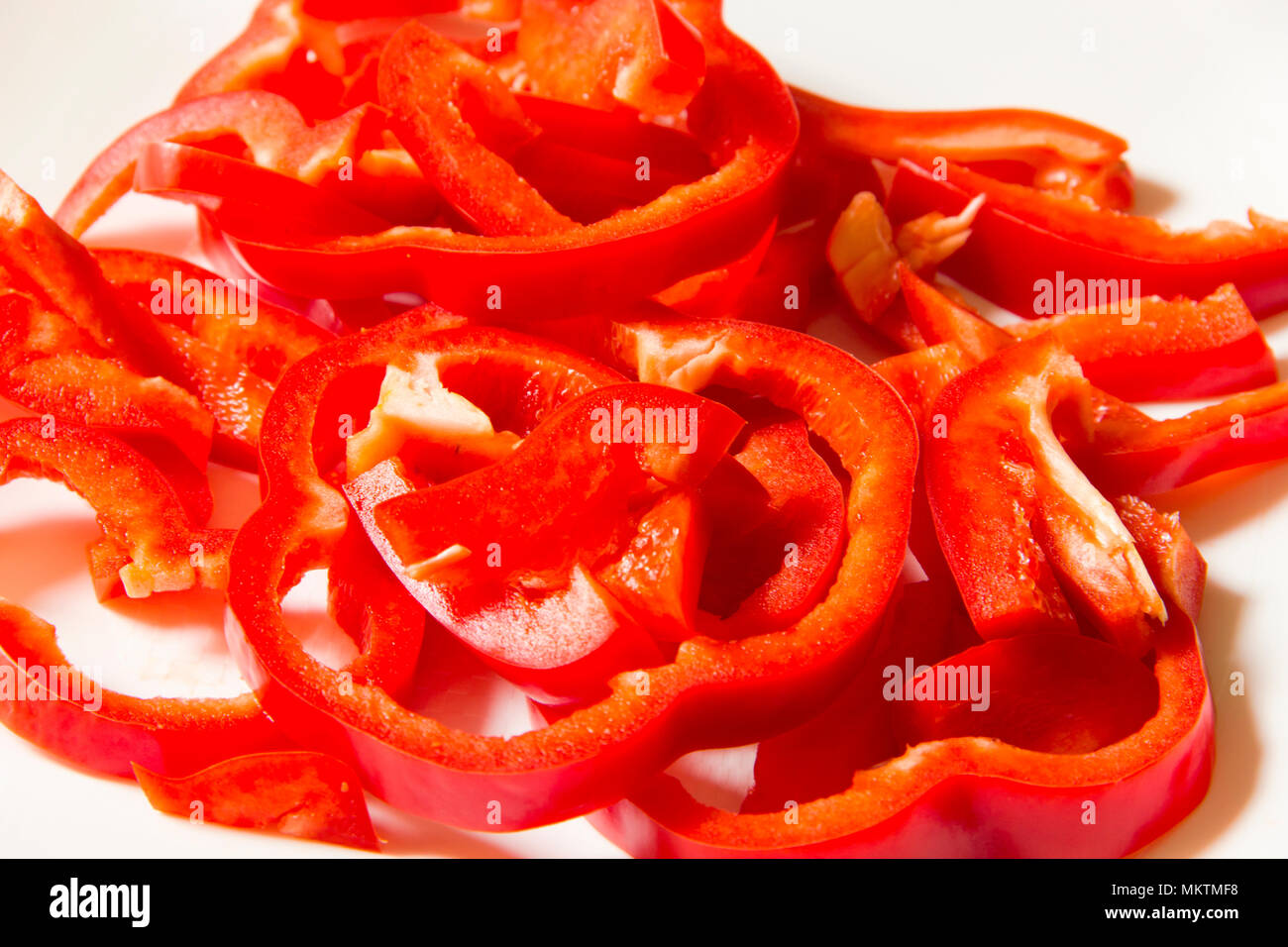 Chopped red sweet pepper on white background Stock Photo - Alamy