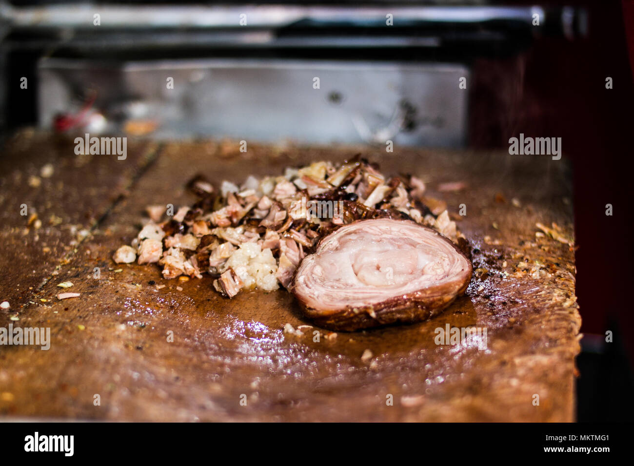 Turkish Street Food Kokorec made with sheep bowel with tomatoes and ...
