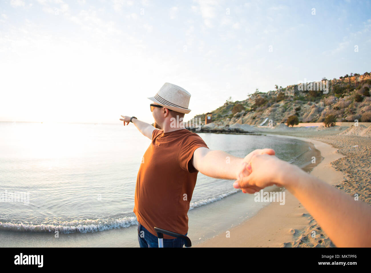 Young man arriving at the resort and standing on the beach Stock Photo ...
