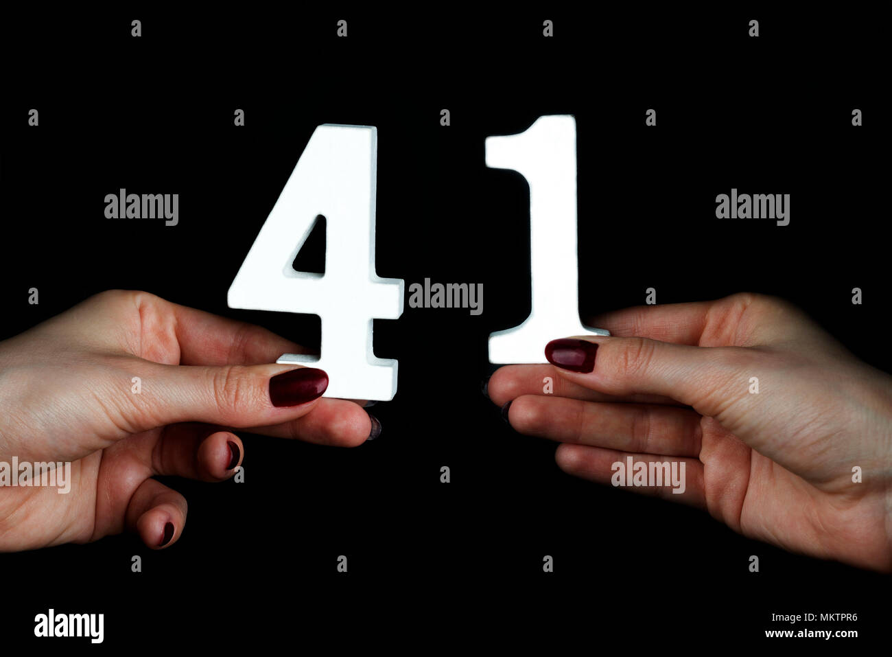 On a black background, female hand with number forty-one Stock Photo ...