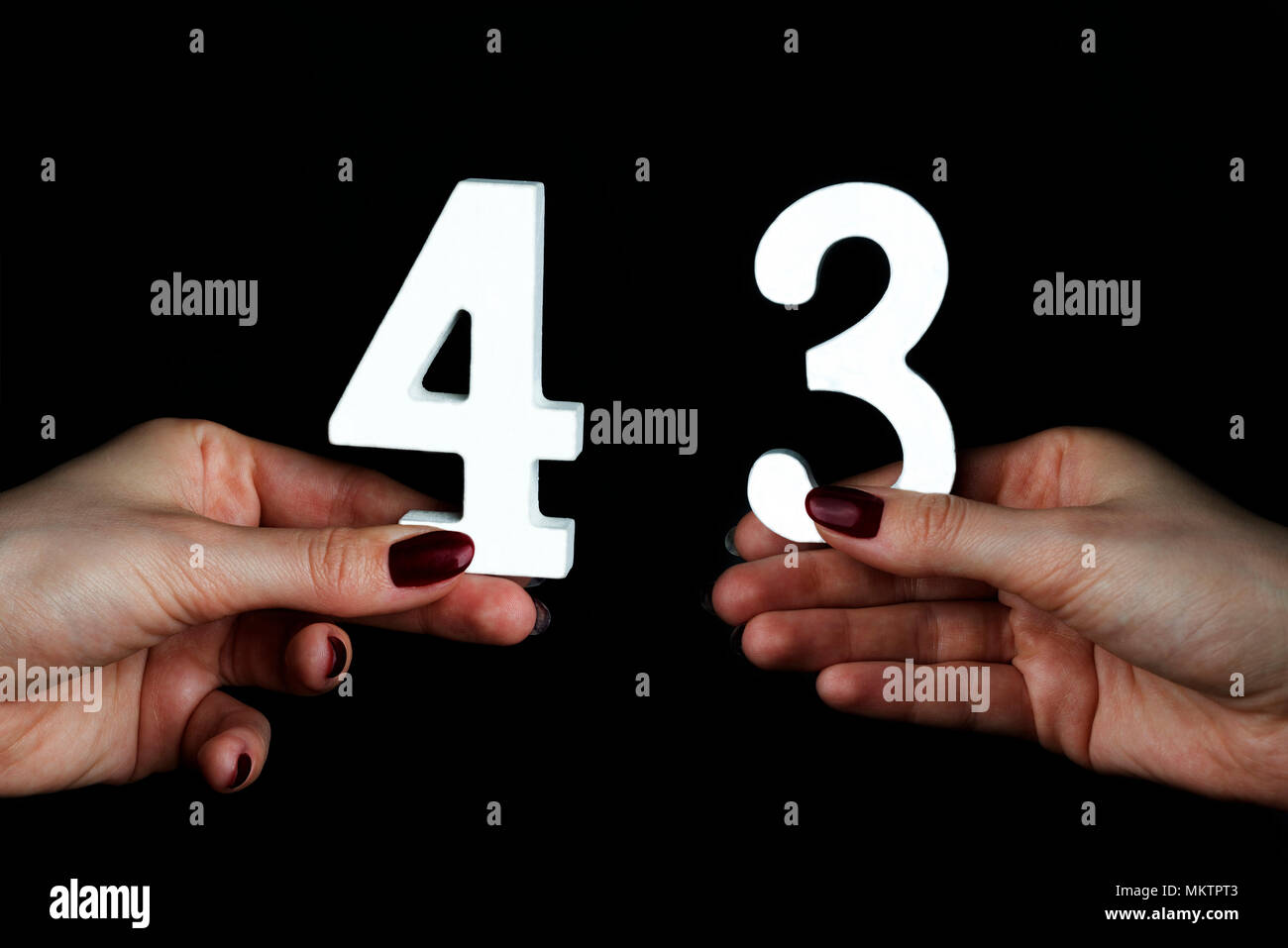 On a black background, female hand with number forty-three Stock Photo ...