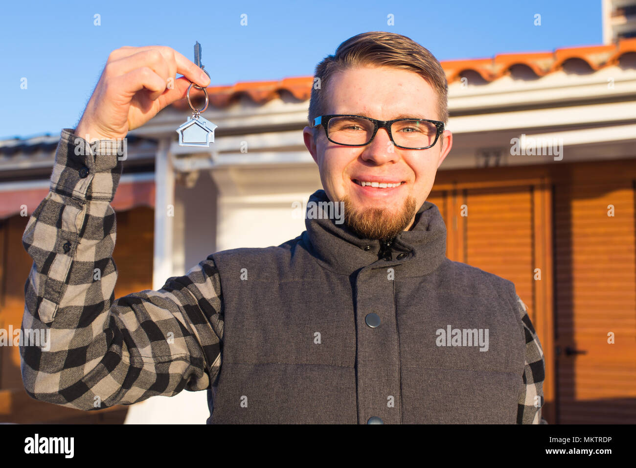 Young happy man showing a house key Stock Photo - Alamy