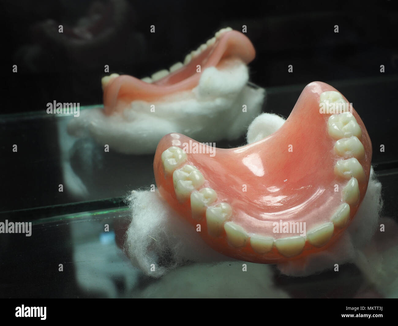 False jaw with white teeth on a black background Stock Photo - Alamy