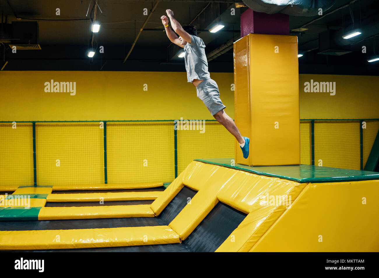 trampoline jumper performs acrobatic exercises on the trampoline Stock ...