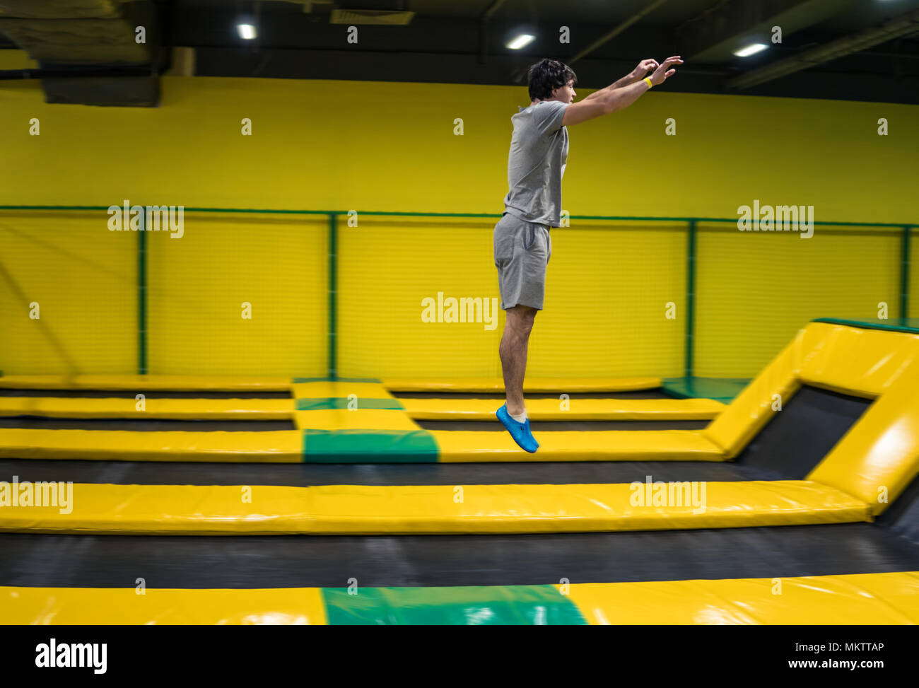 trampoline jumper performs acrobatic exercises on the trampoline Stock ...
