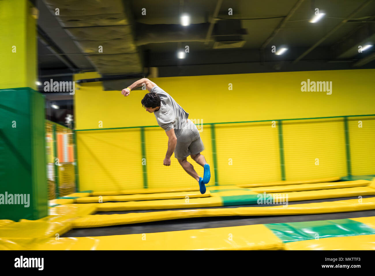 trampoline jumper performs acrobatic exercises on the trampoline Stock ...
