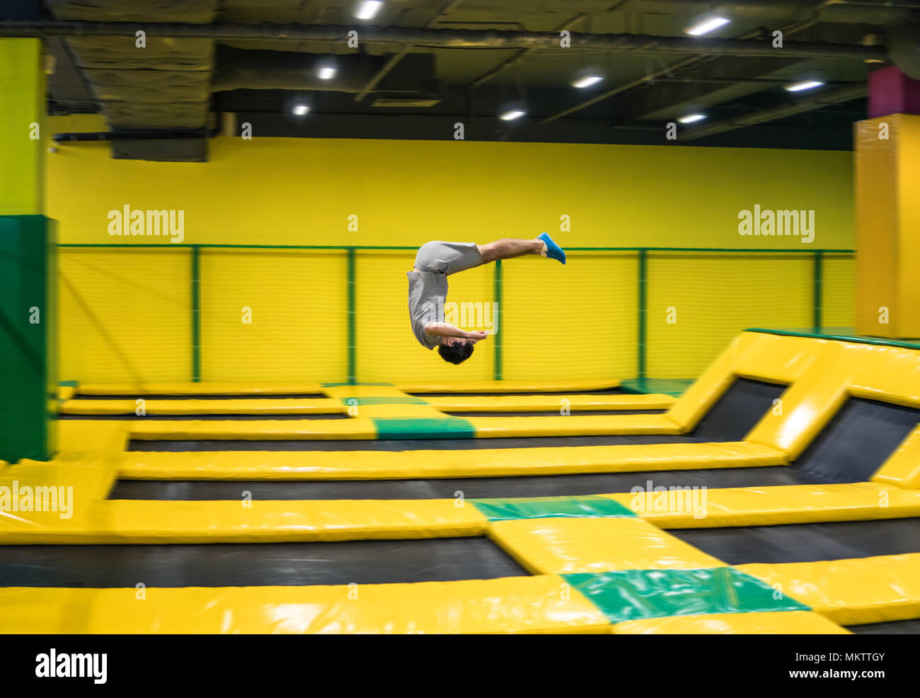 trampoline jumper performs acrobatic exercises on the trampoline Stock ...