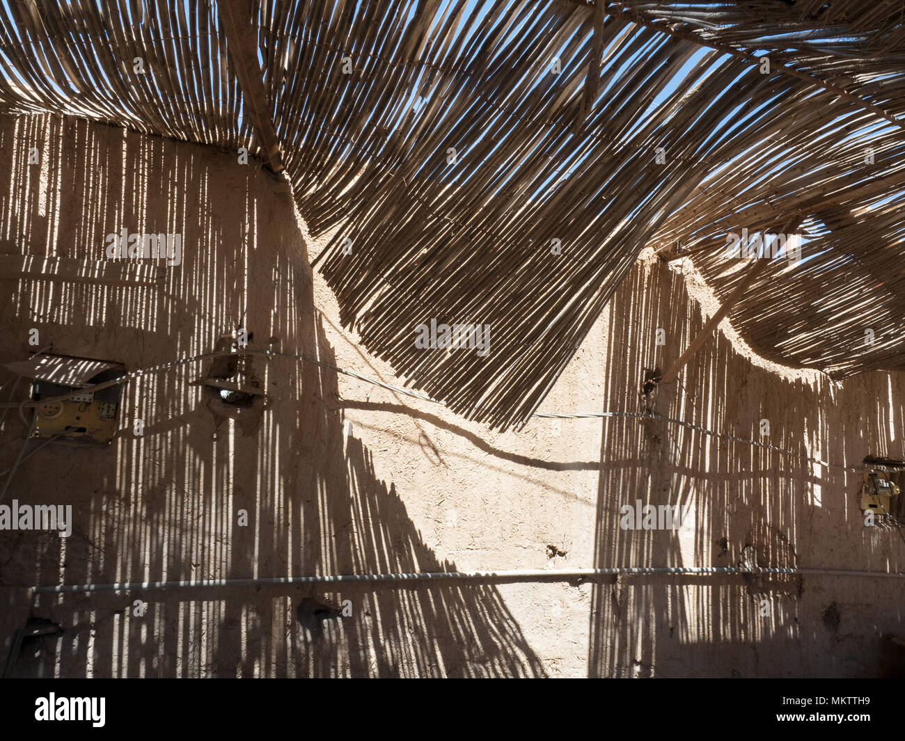 Thunder canopy on a bright sunny day casts striped shadows on a white ...