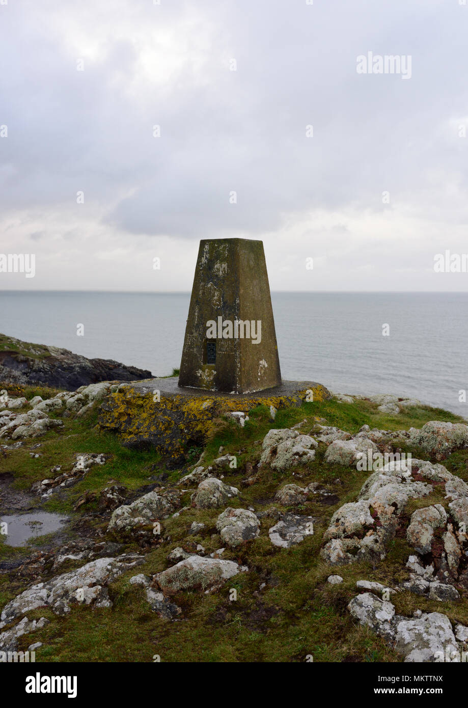Trig point or triangulation pillar on wales coast path overlooking the ...