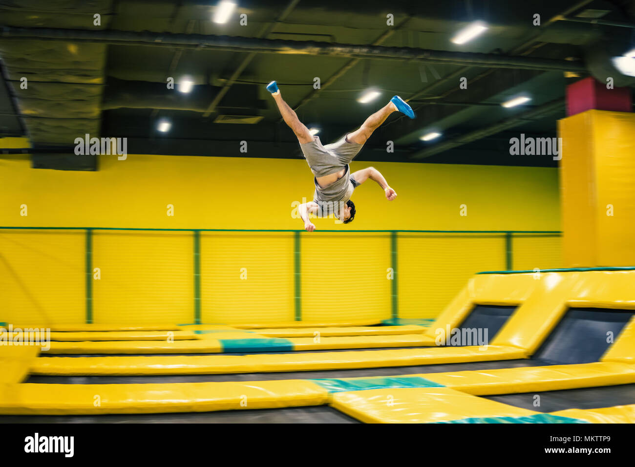trampoline jumper performs acrobatic exercises on the trampoline Stock ...