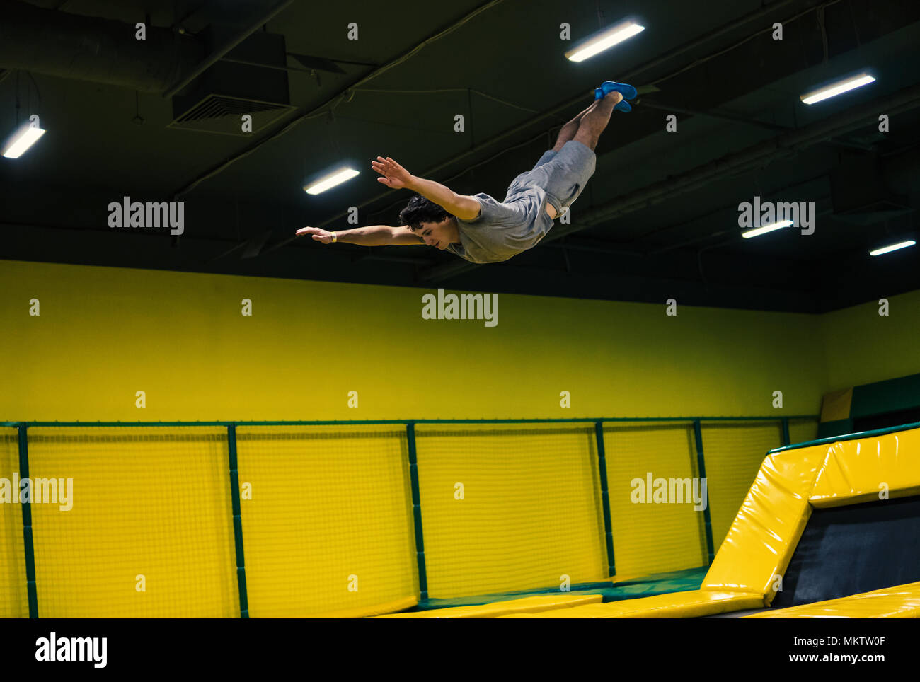 trampoline jumper performs acrobatic exercises on the trampoline Stock ...