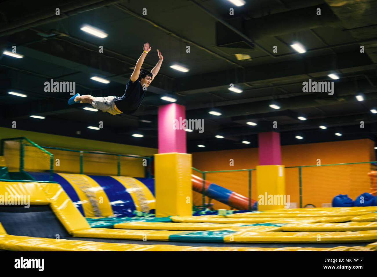 trampoline jumper performs acrobatic exercises on the trampoline Stock ...