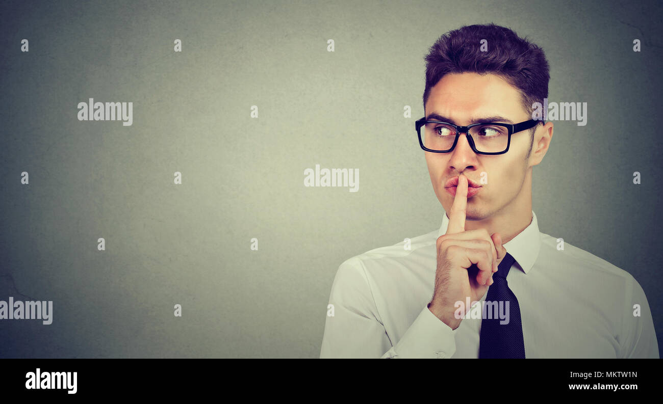 Secret guy. Man saying hush be quiet with finger on lips gesture ...