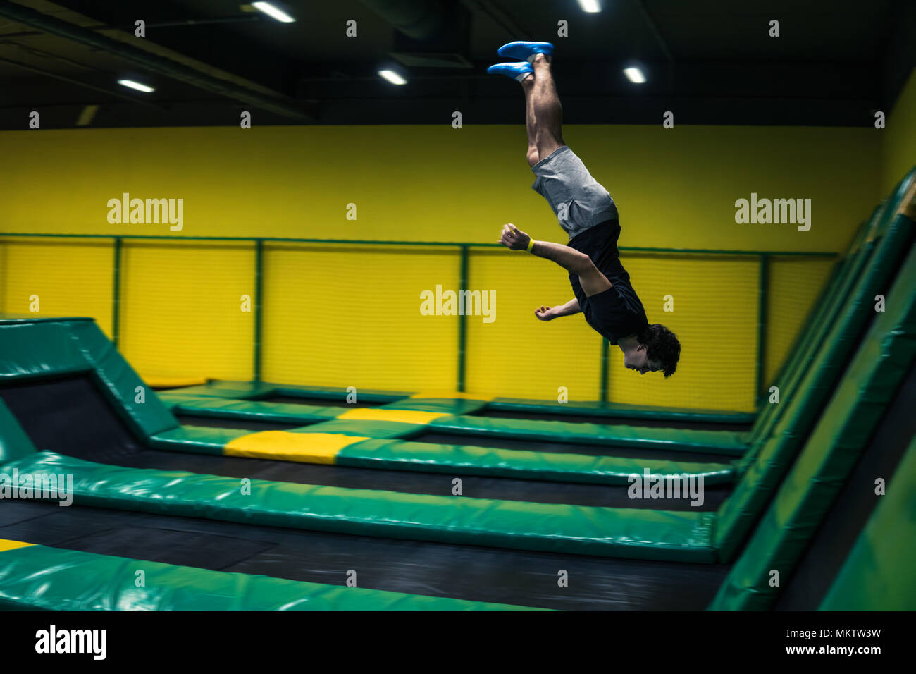 trampoline jumper performs acrobatic exercises on the trampoline Stock ...