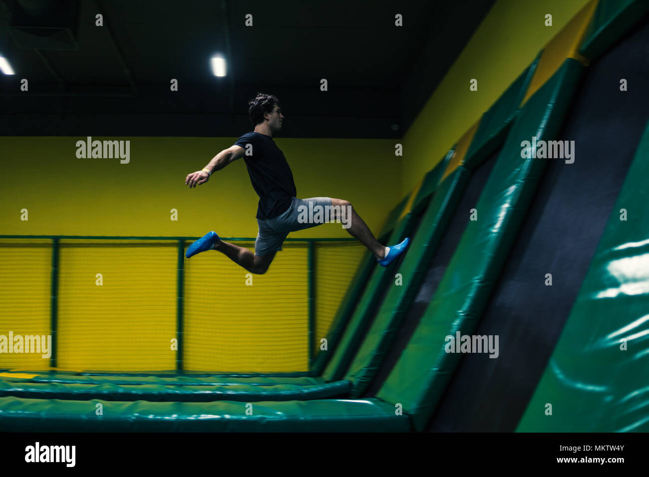 trampoline jumper performs acrobatic exercises on the trampoline Stock ...