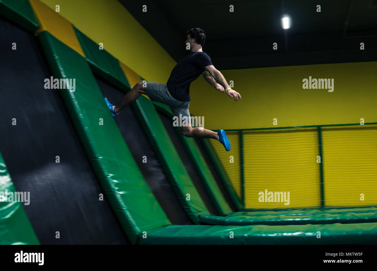 trampoline jumper performs acrobatic exercises on the trampoline Stock ...