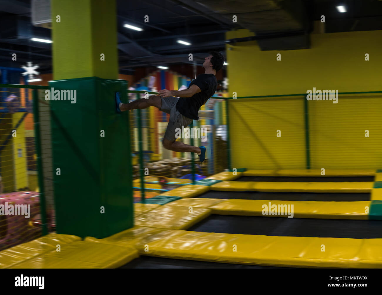 trampoline jumper performs acrobatic exercises on the trampoline Stock ...
