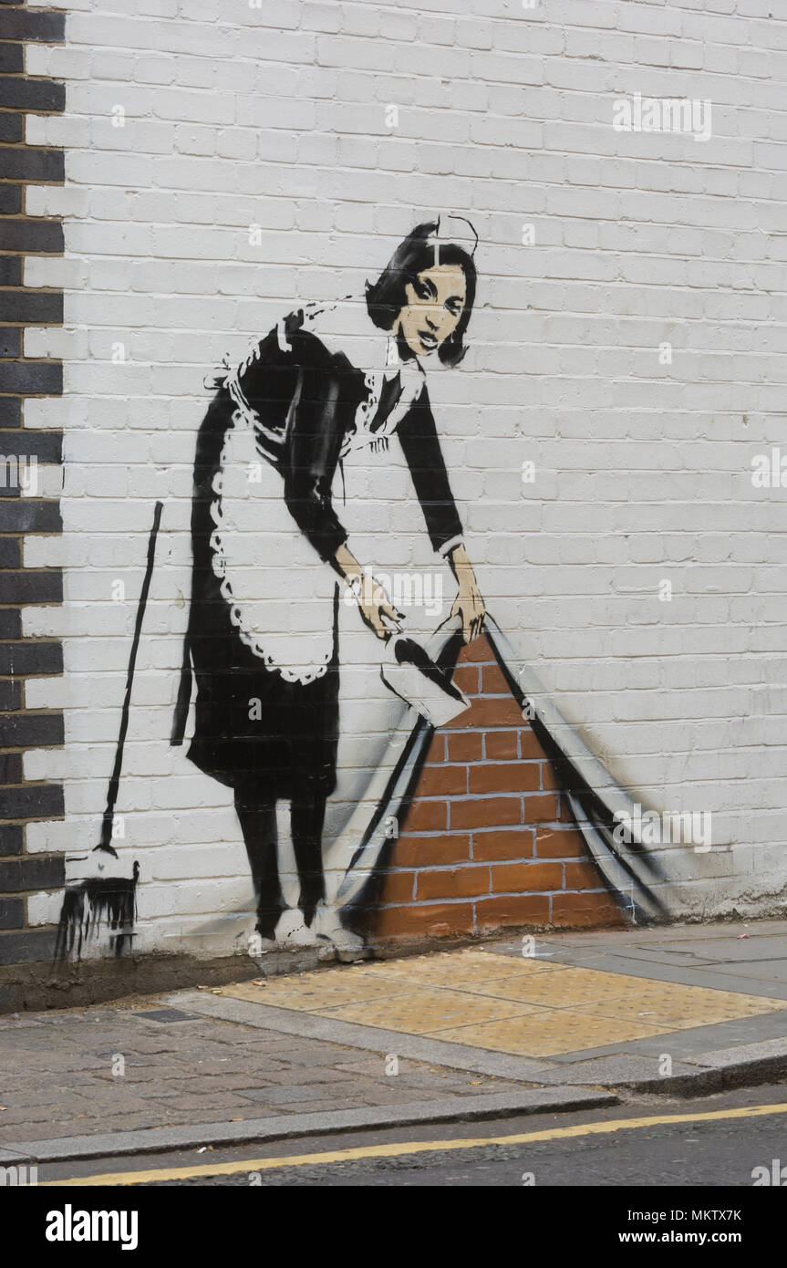 Banksy's Maid Sweeping It Under The Carpet, painted on the wall of the ...