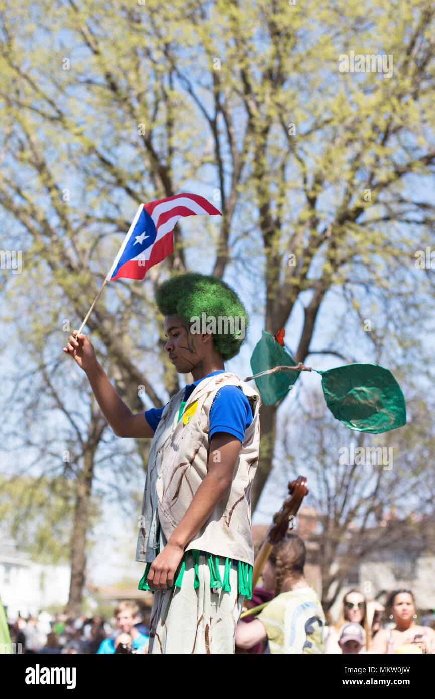 A young black man with a green afro at the May Day parade and festival ...