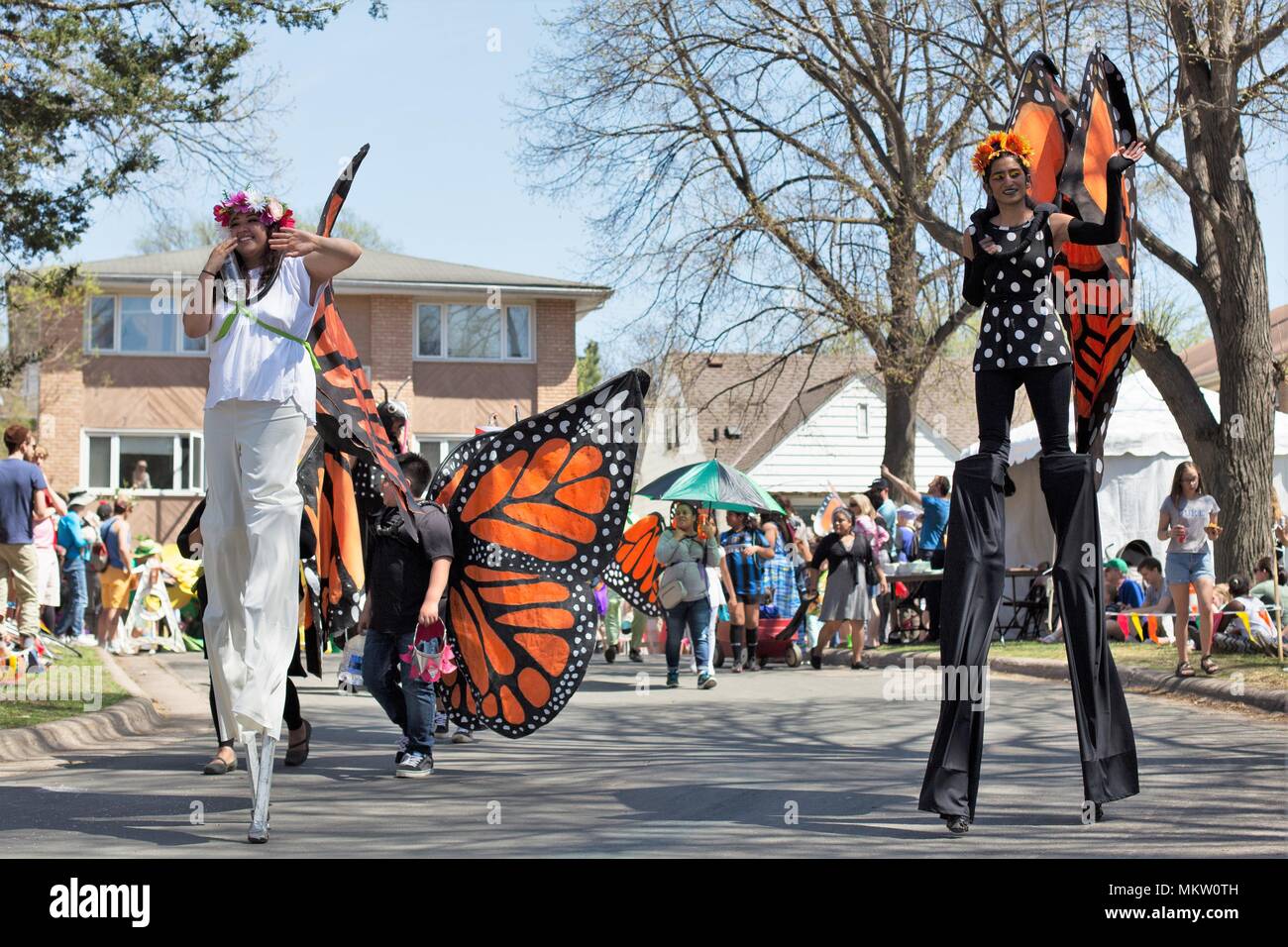 People on stilts dressed as butterflies at the May Day parade and ...