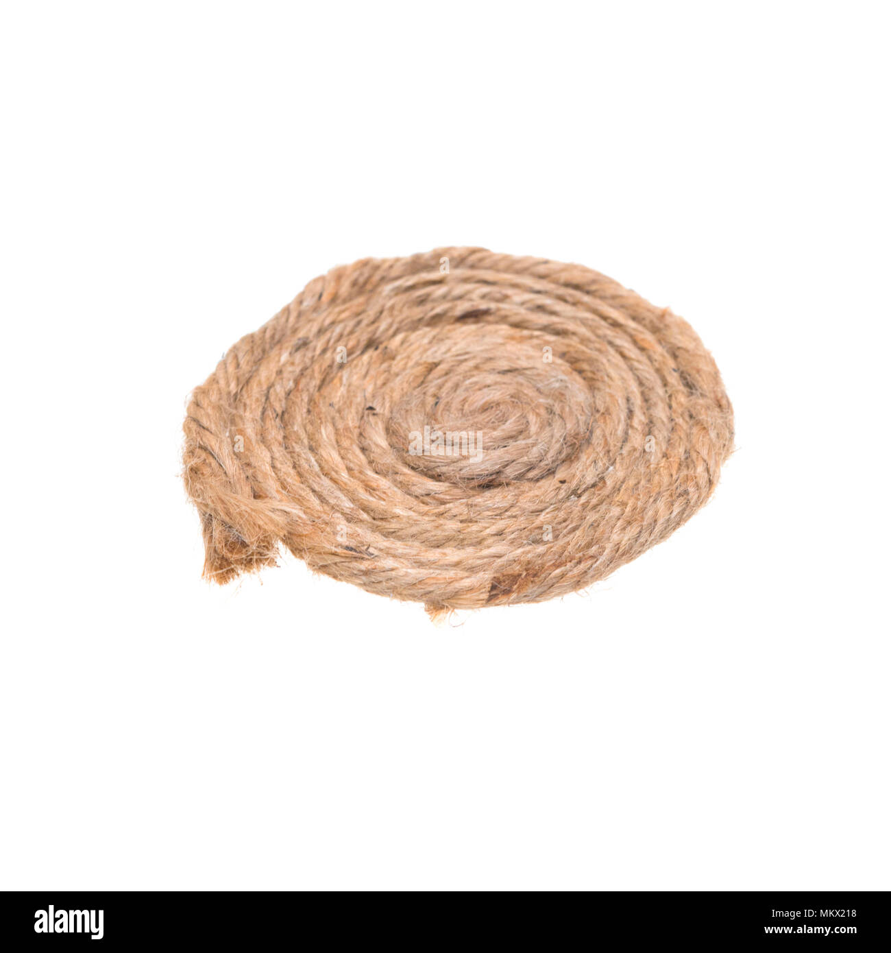 Hemp three strand rope coiled in a circluar pattern isolated against a ...
