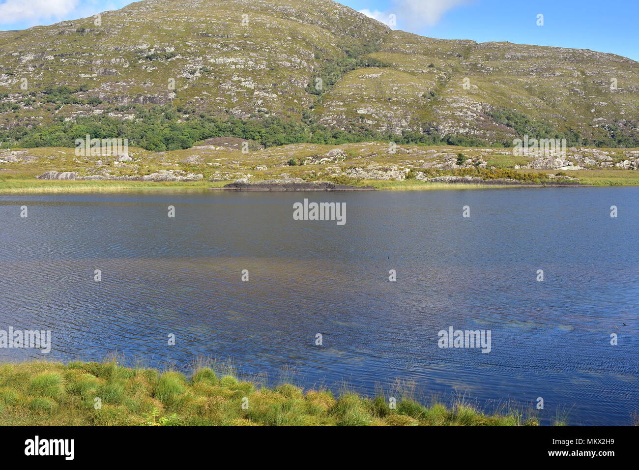 Calm water of lake near Reeks mountain range in Kerry Stock Photo - Alamy