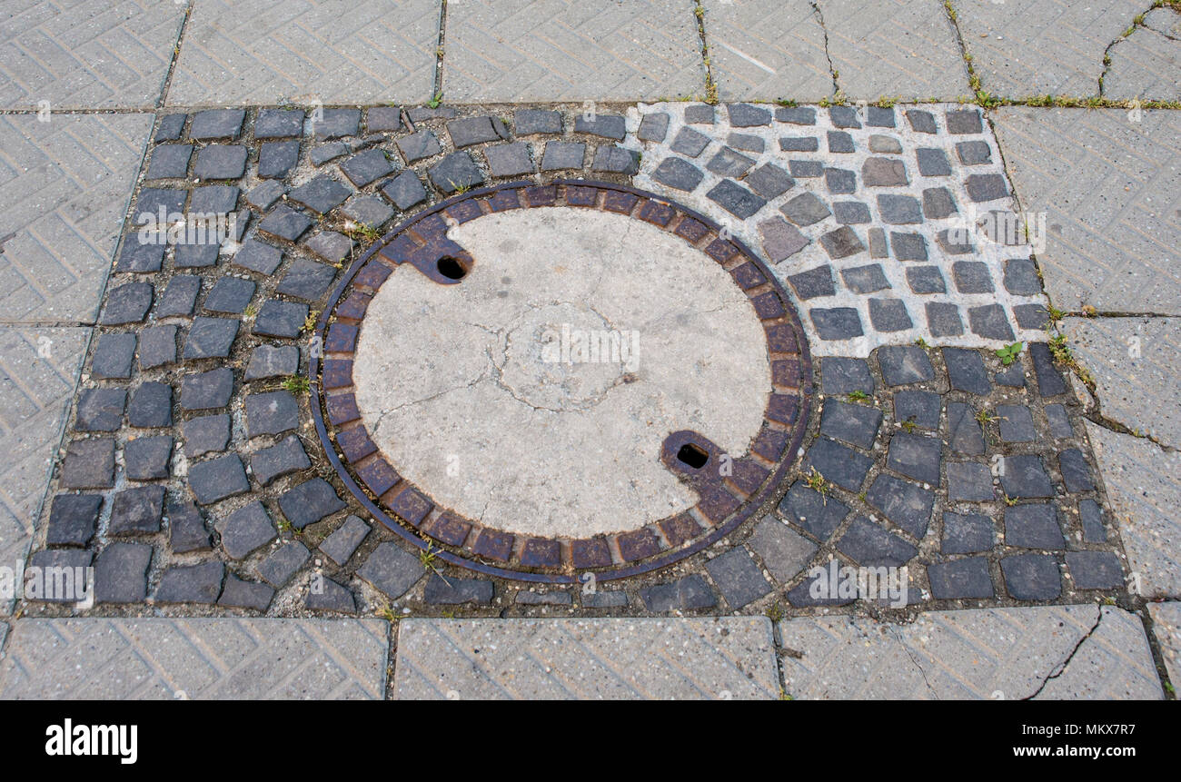 Repaired man hole cover on the square Stock Photo - Alamy