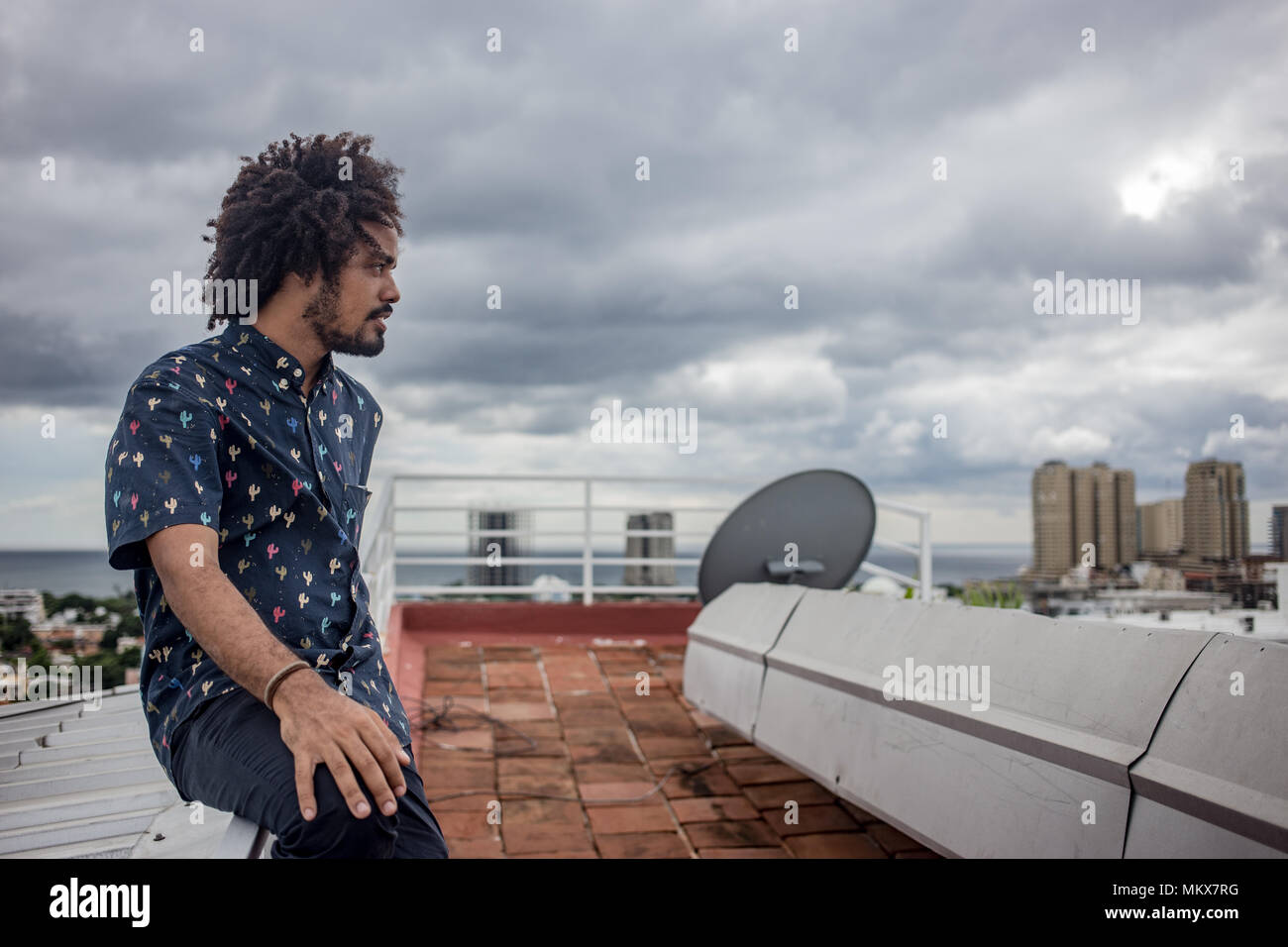 Young man on rooftop in Santo Domingo Stock Photo - Alamy