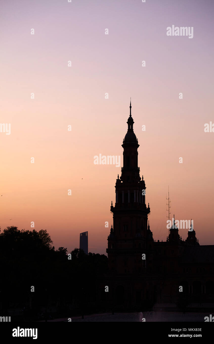 The tower at sunset in Plaza de España (Spain Square) in Seville, Spain ...