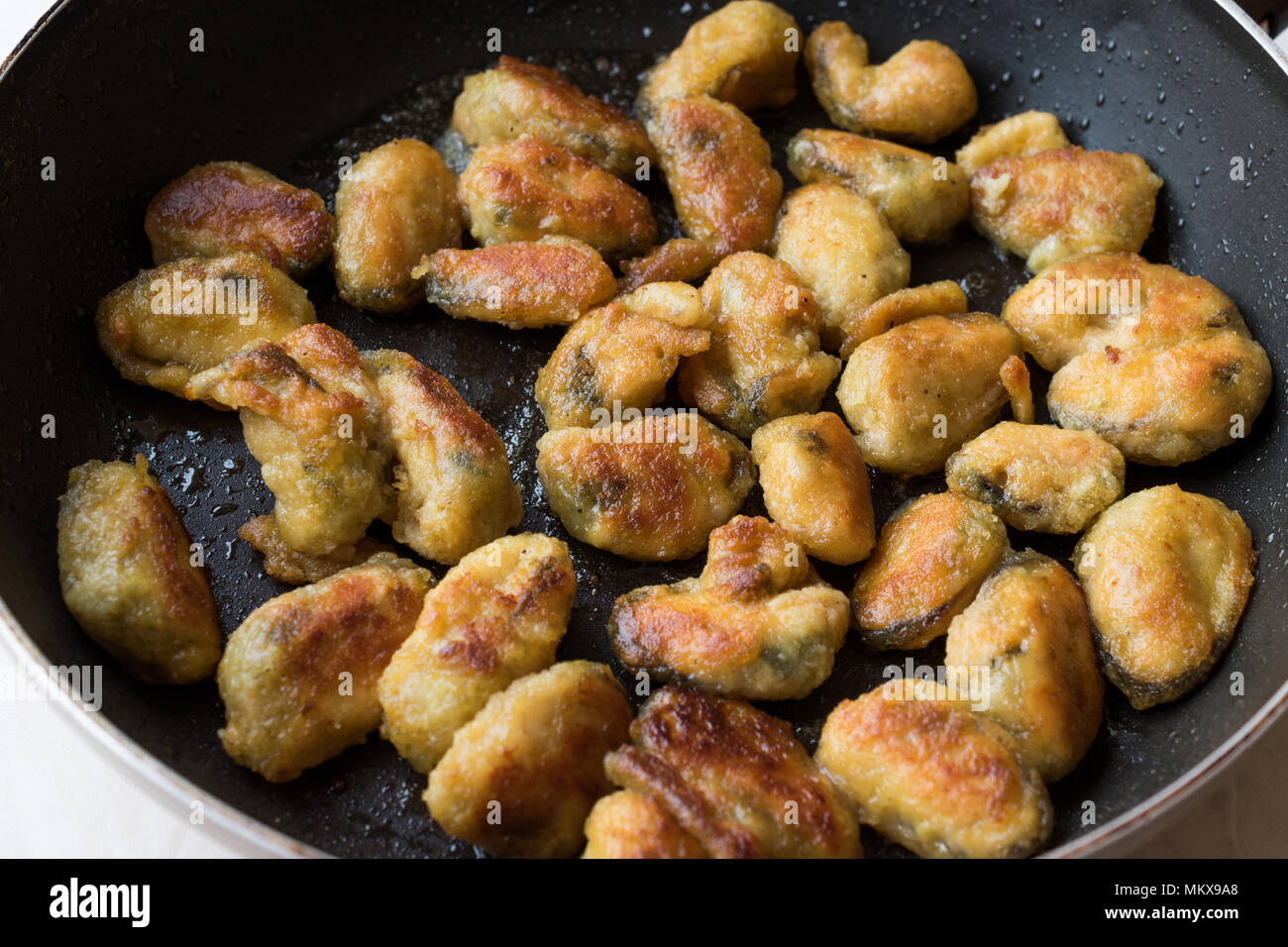 Fried Crispy Mussels Cooked in Pan. Seafood concept Stock Photo - Alamy