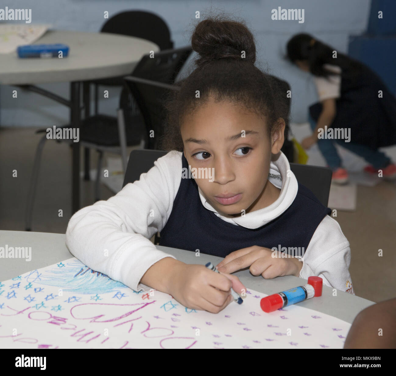 Children do school homework at an after school community center program ...