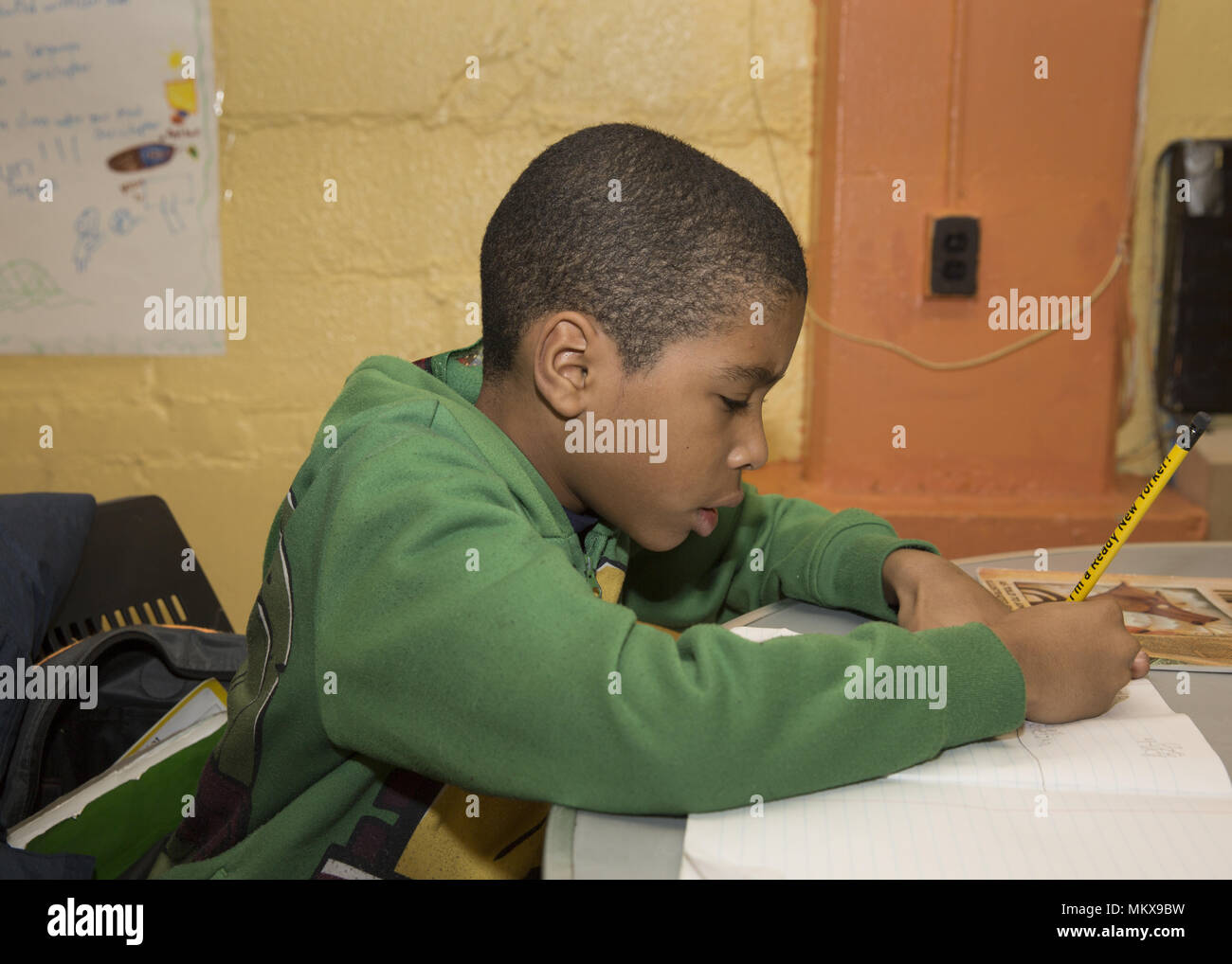 Children do school homework at an after school community center program ...